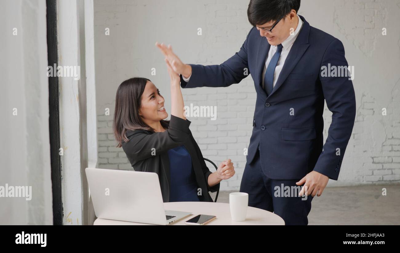 Yes! Happy excited successful, Asian businessman and woman smile ...