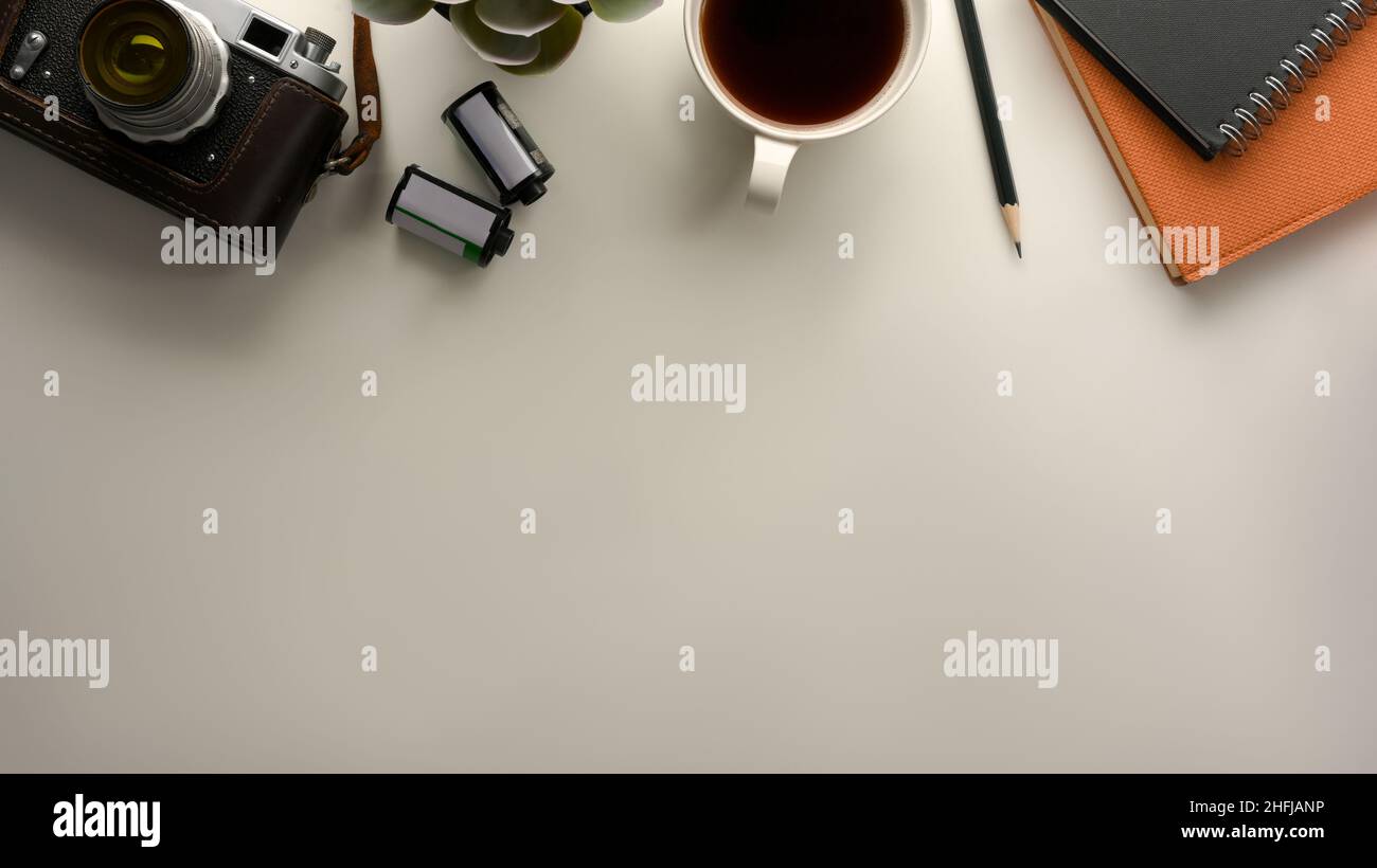 Photographer office desk concept, A camera, coffee cup, books and copy ...