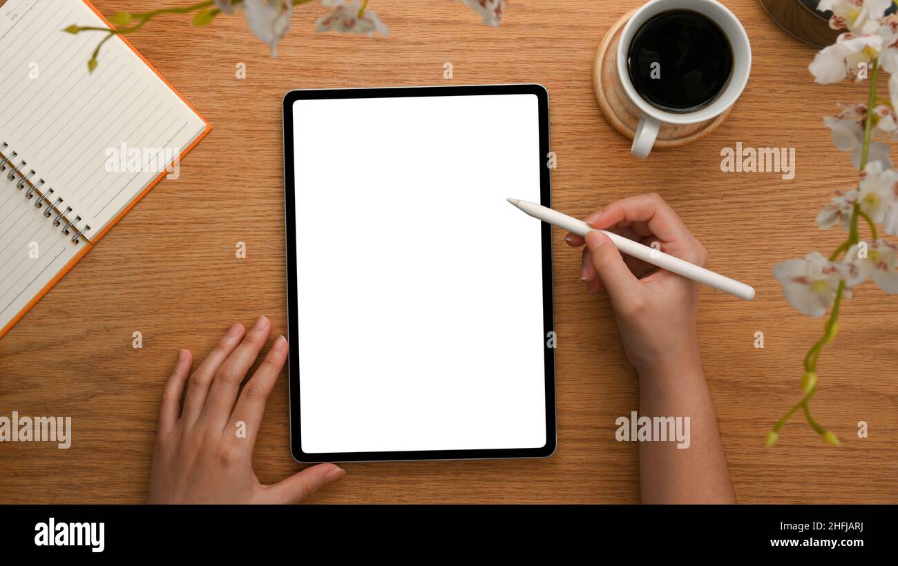 Top view, close-up shot of a female's hand drawing on digital tablet ...