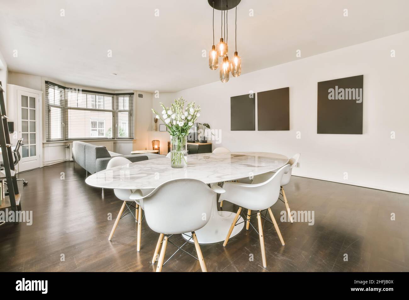 Stylish and cozy dining area with a table and chairs Stock Photo - Alamy