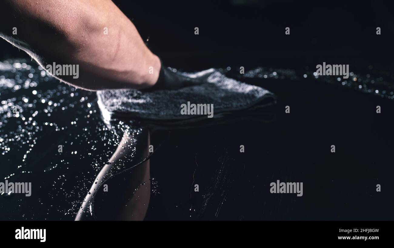 Using rag in palm of your hand, drops are removed from the car. Drop ...