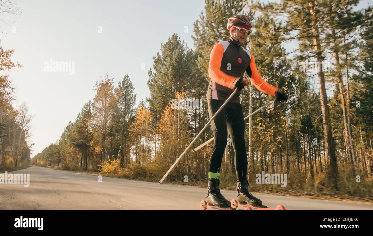 Training an athlete on the roller skaters. Biathlon ride on the roller ...