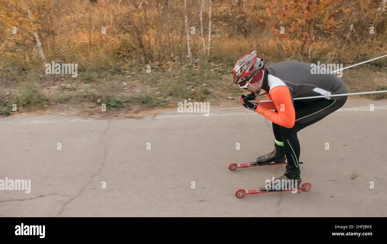 Training an athlete on the roller skaters. Biathlon ride on the roller ...