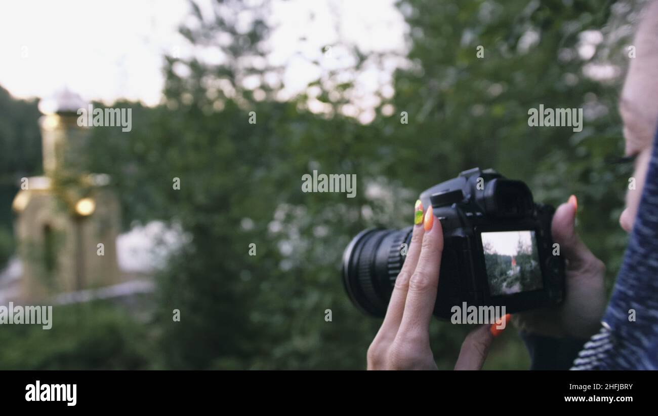 Traveler photographing scenic view in forest. One caucasian woman ...