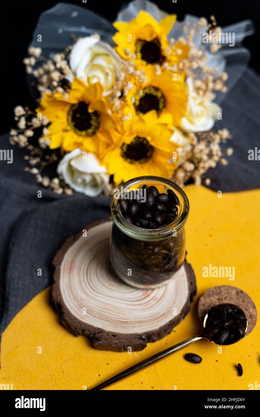 Coffee beans and yellow bouquet of flowers ond yellow and grey ...