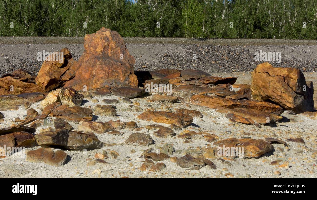 Beautiful brown stones of diferent size under the summer sun on quarry ...