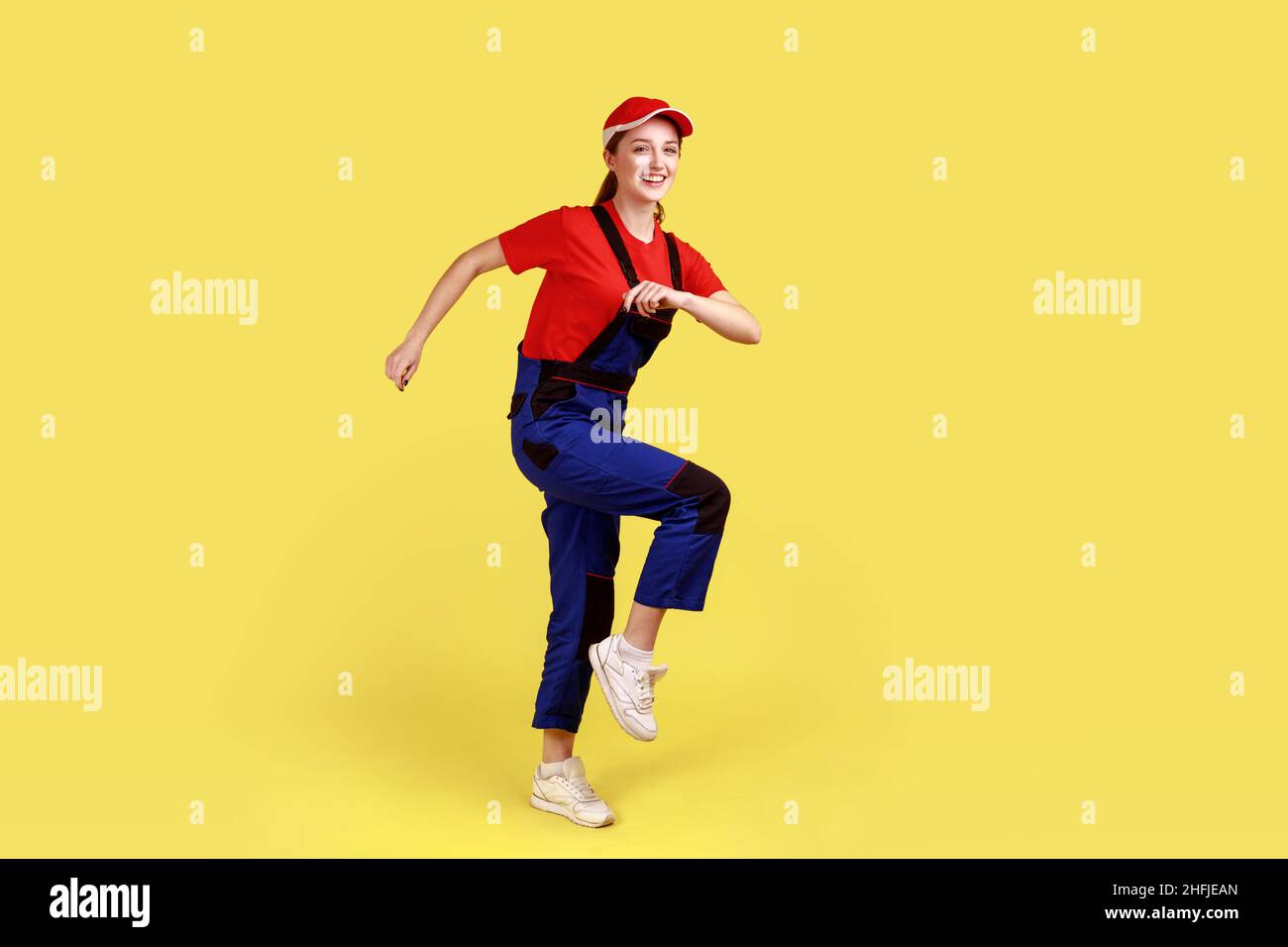 Full length portrait of optimistic positive worker woman marching ...