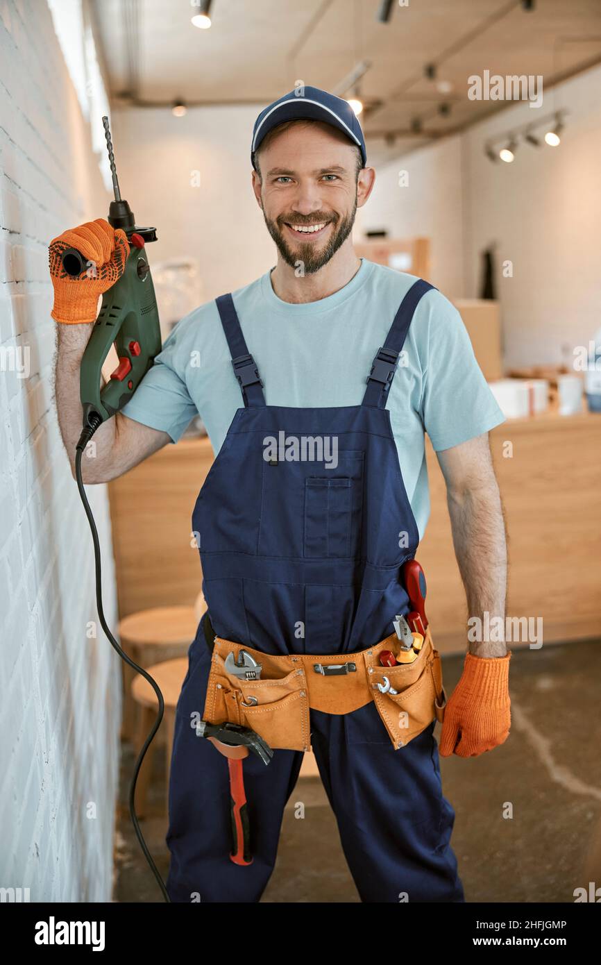 Repairman holding drilling machine hi-res stock photography and images ...