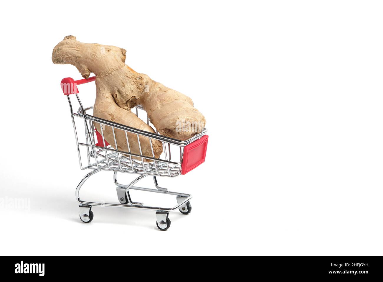 Ginger root in a shopping cart on a white background Stock Photo - Alamy