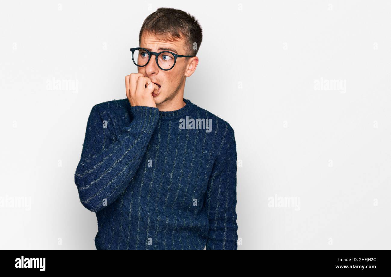 Young blond man wearing casual clothes and glasses looking stressed and ...