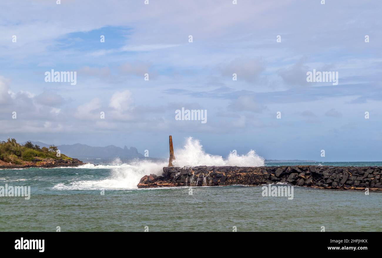 Waves crashing on the old harbor light tower at Ahukini Recreational ...