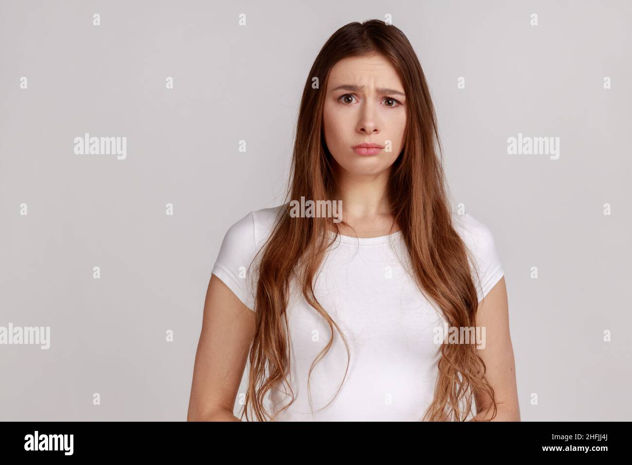 Portrait of disappointed woman being upset of bad news, looking at ...