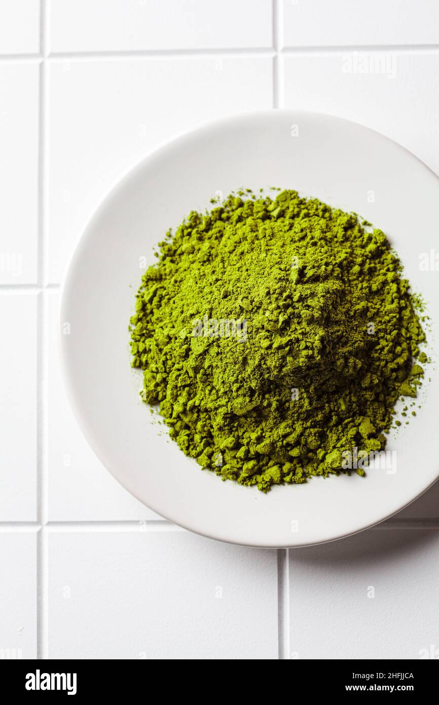 Matcha green tea powder on a white plate, top view, copy space ...