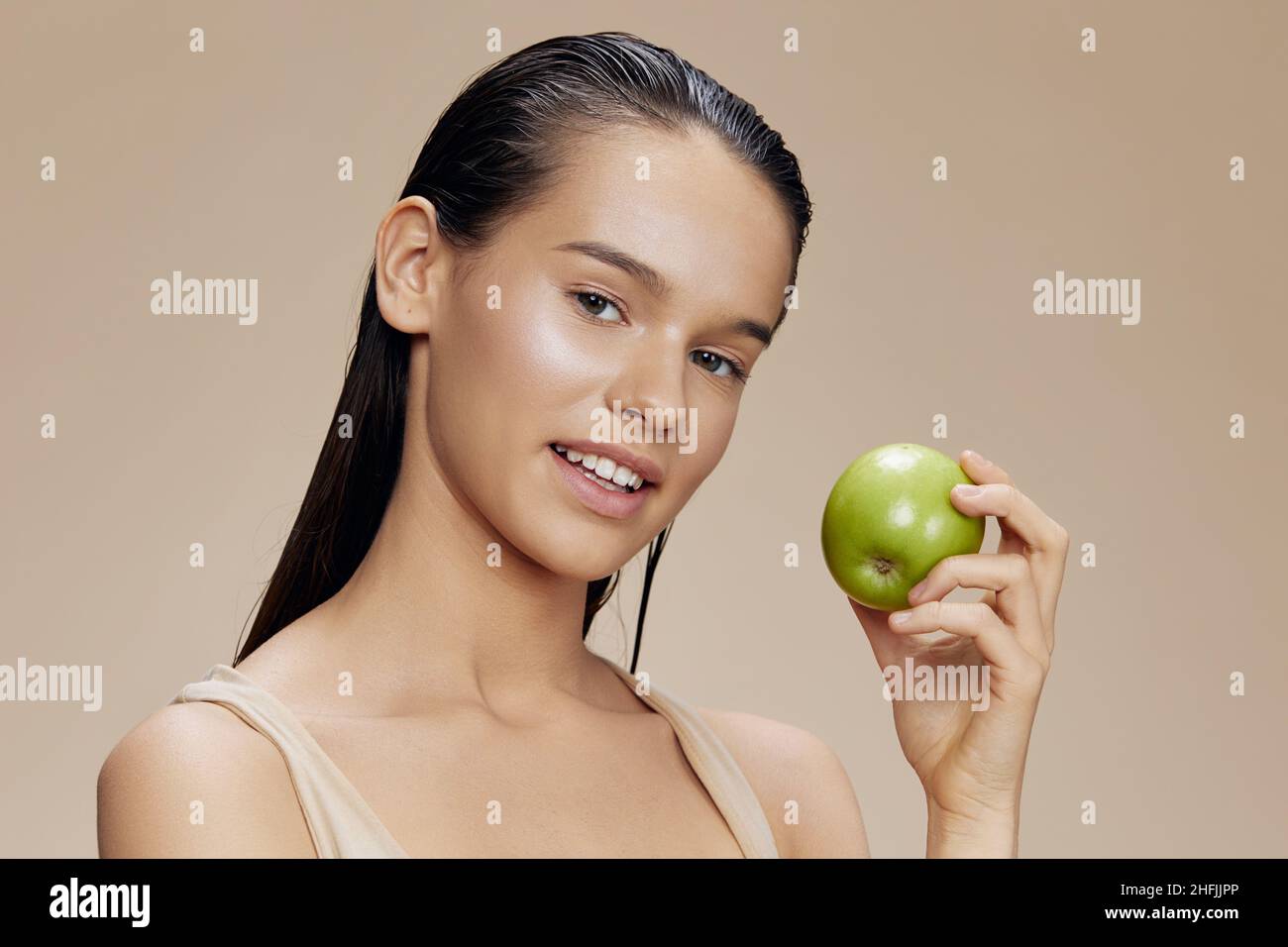 brunette apple in hands posing fruit healthy food fresh beige ...