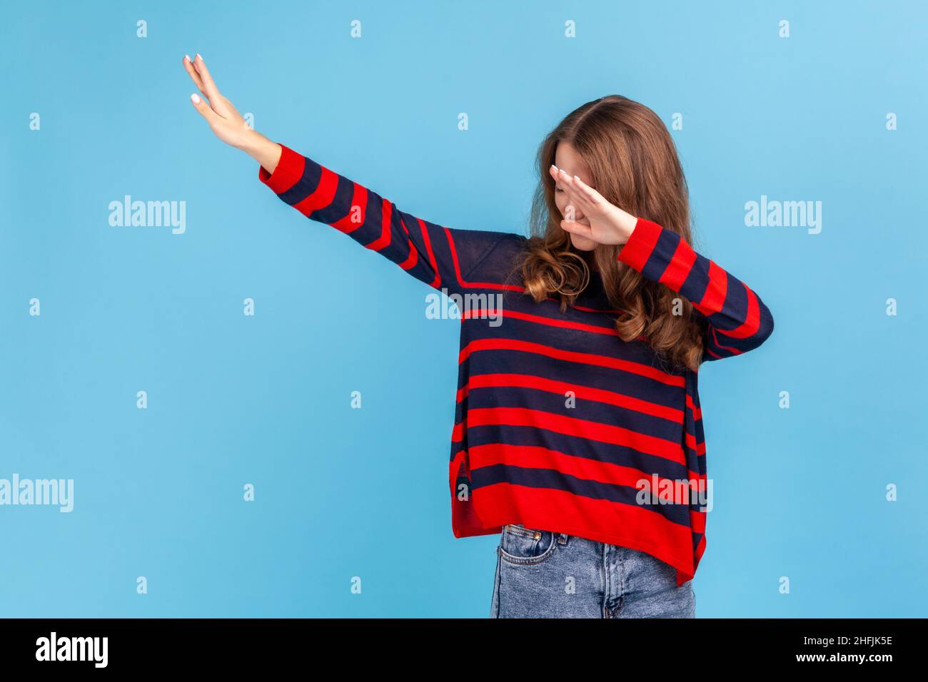 Winning, success gesture. Portrait of woman in striped casual style ...