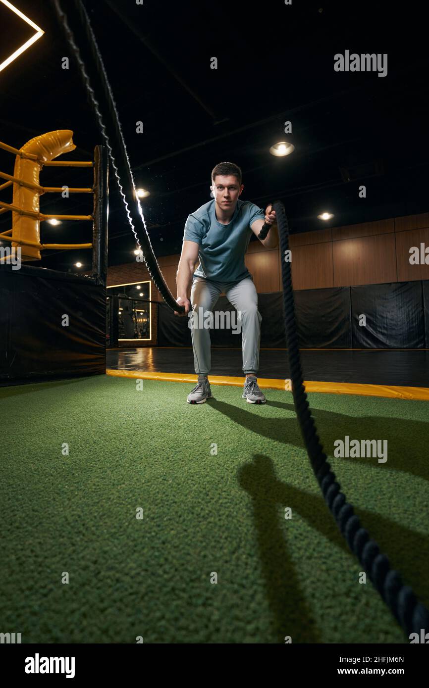 Focused sporty young man performing high-intensity workout Stock Photo ...