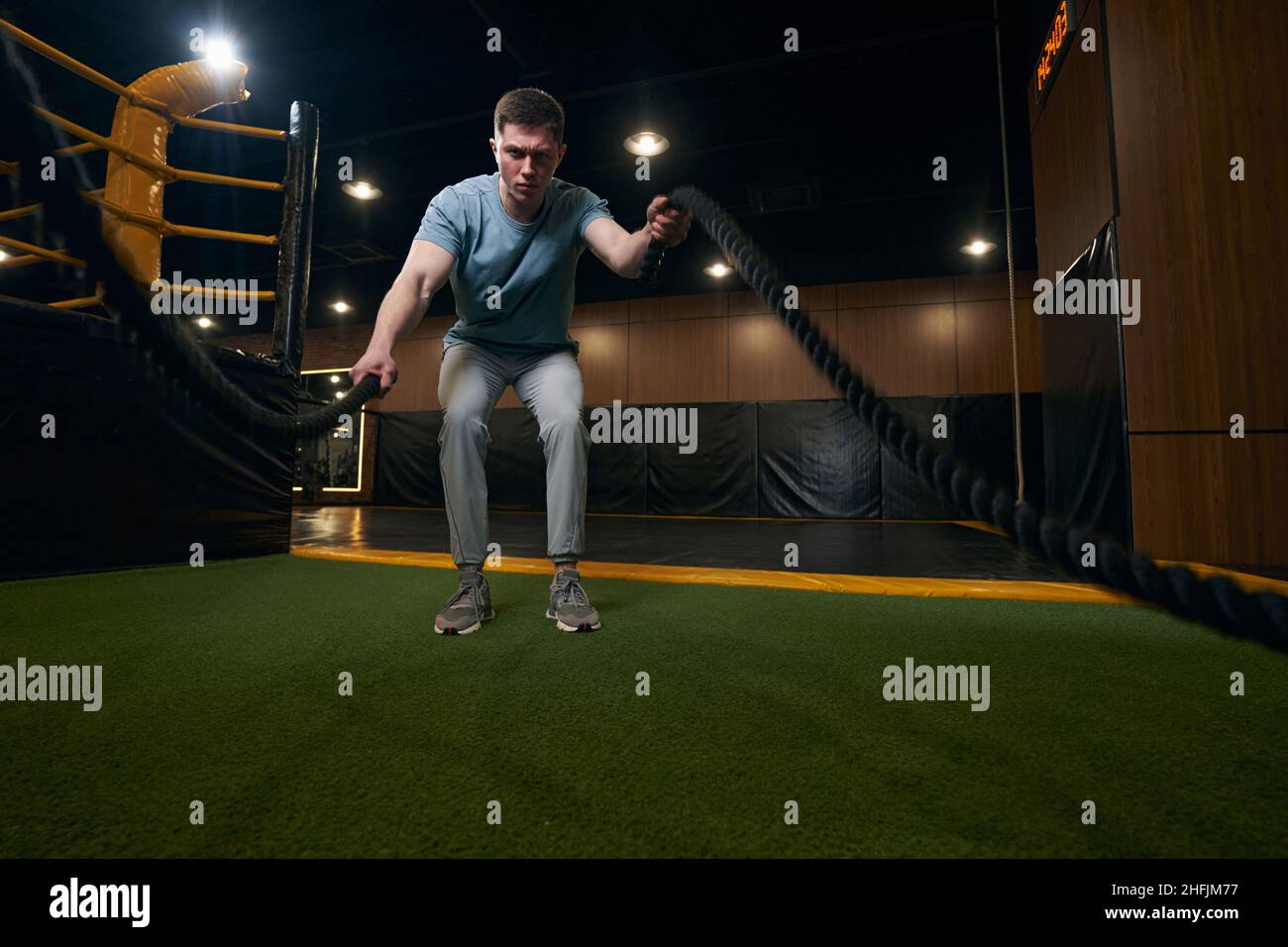 Concentrated athlete doing high-intensity workout at gym Stock Photo ...