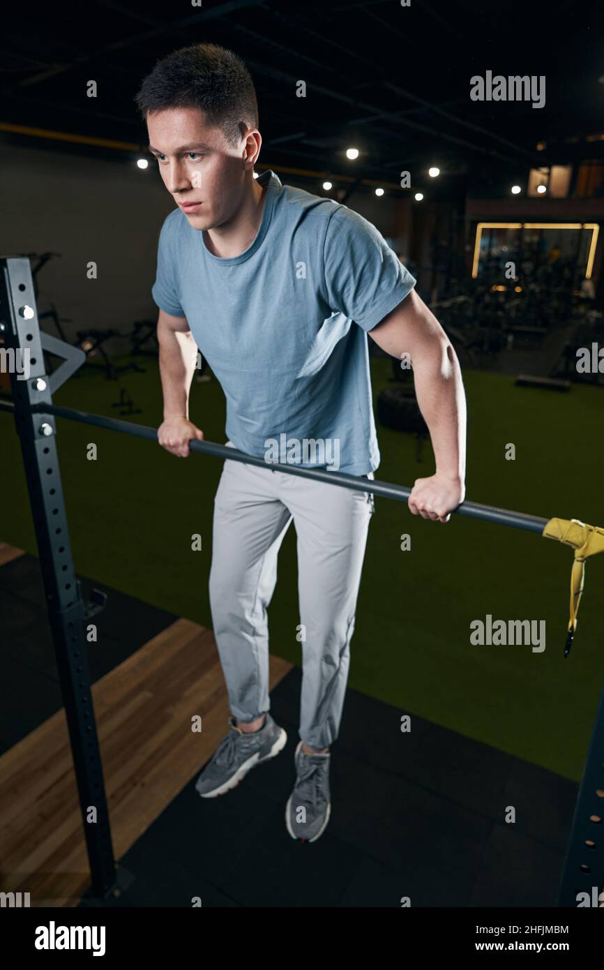 Concentrated male athlete performing advanced strength-training ...