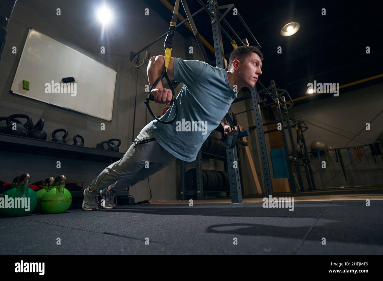 Focused calm male athlete performing chest press Stock Photo - Alamy