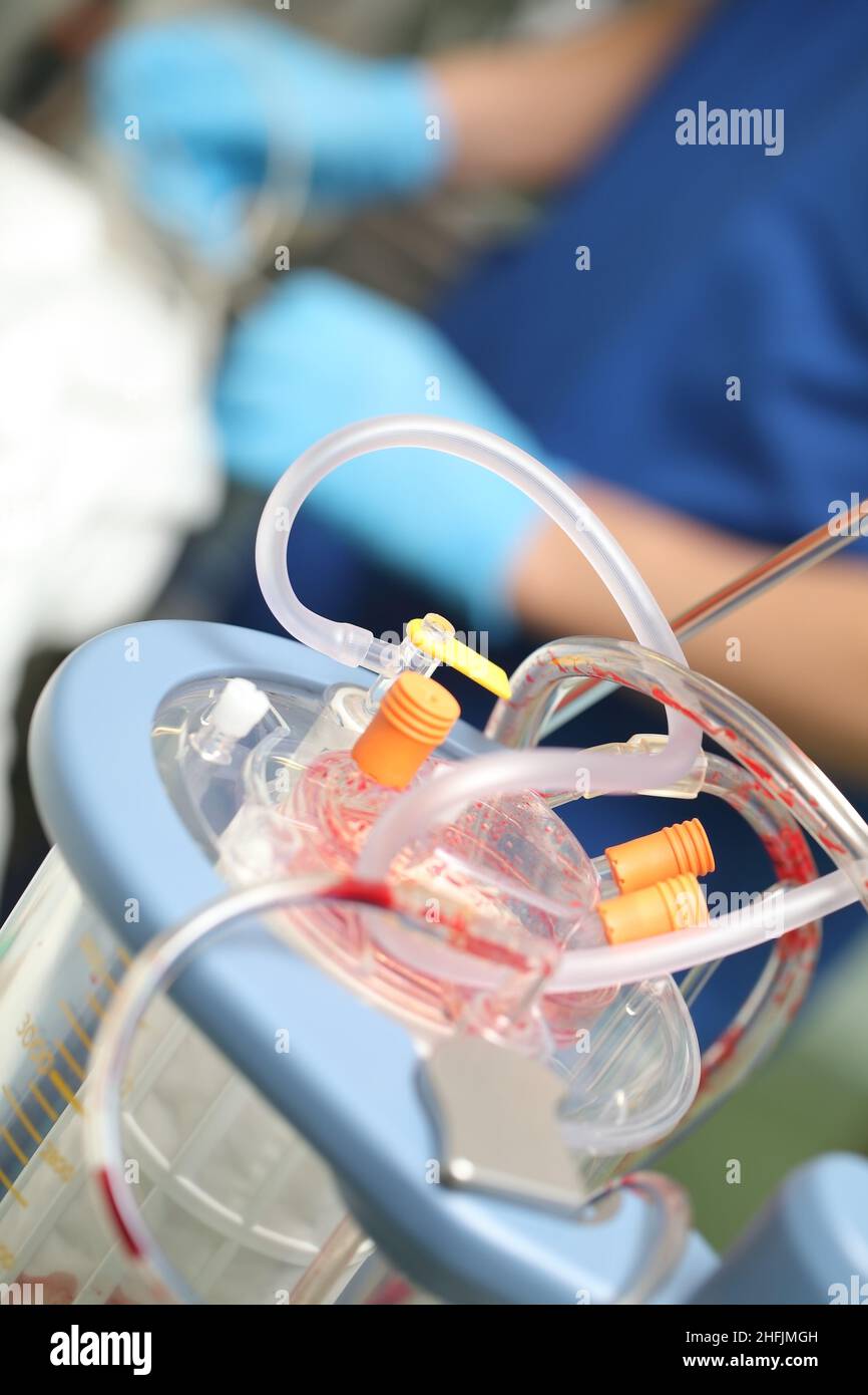Plastic collector with traces of blood inside it, on the background of ...