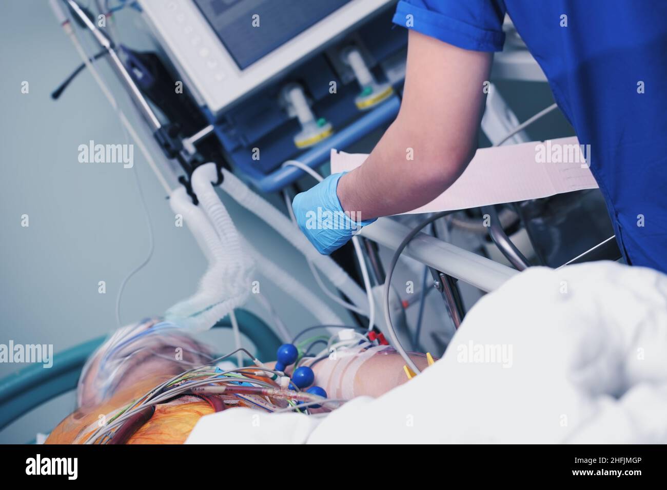 Unconsciuos patient on the artificial lung ventilation with ECG ...