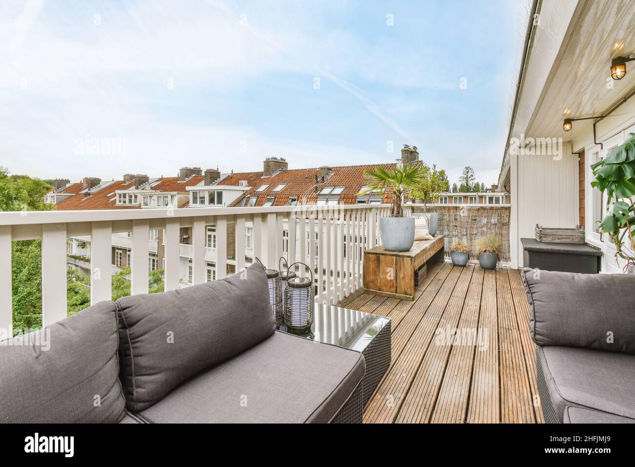 Luxurious balcony with gray sofa and wooden floor Stock Photo - Alamy