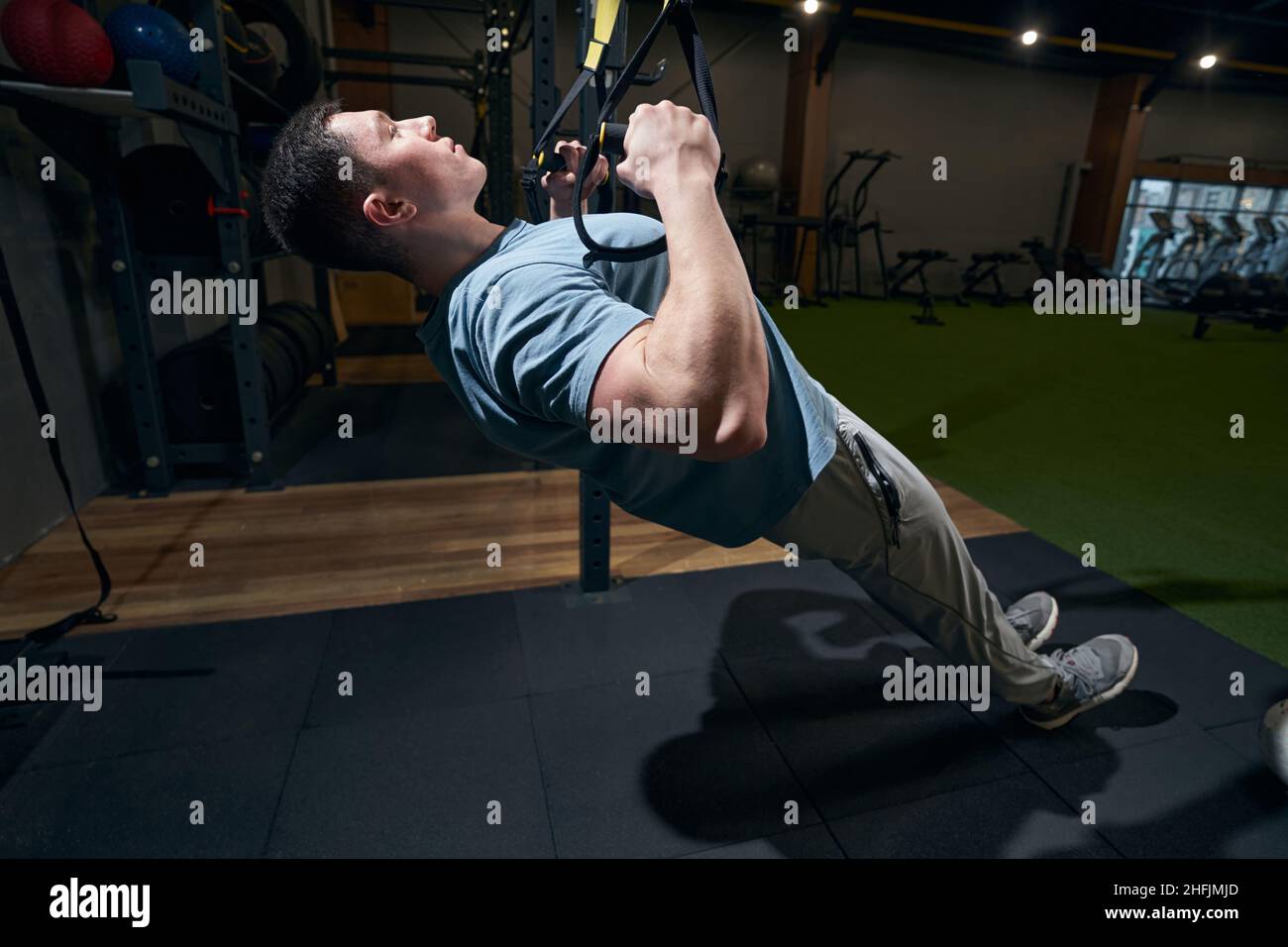 Concentrated calm sportsperson doing total resistance exercise Stock ...