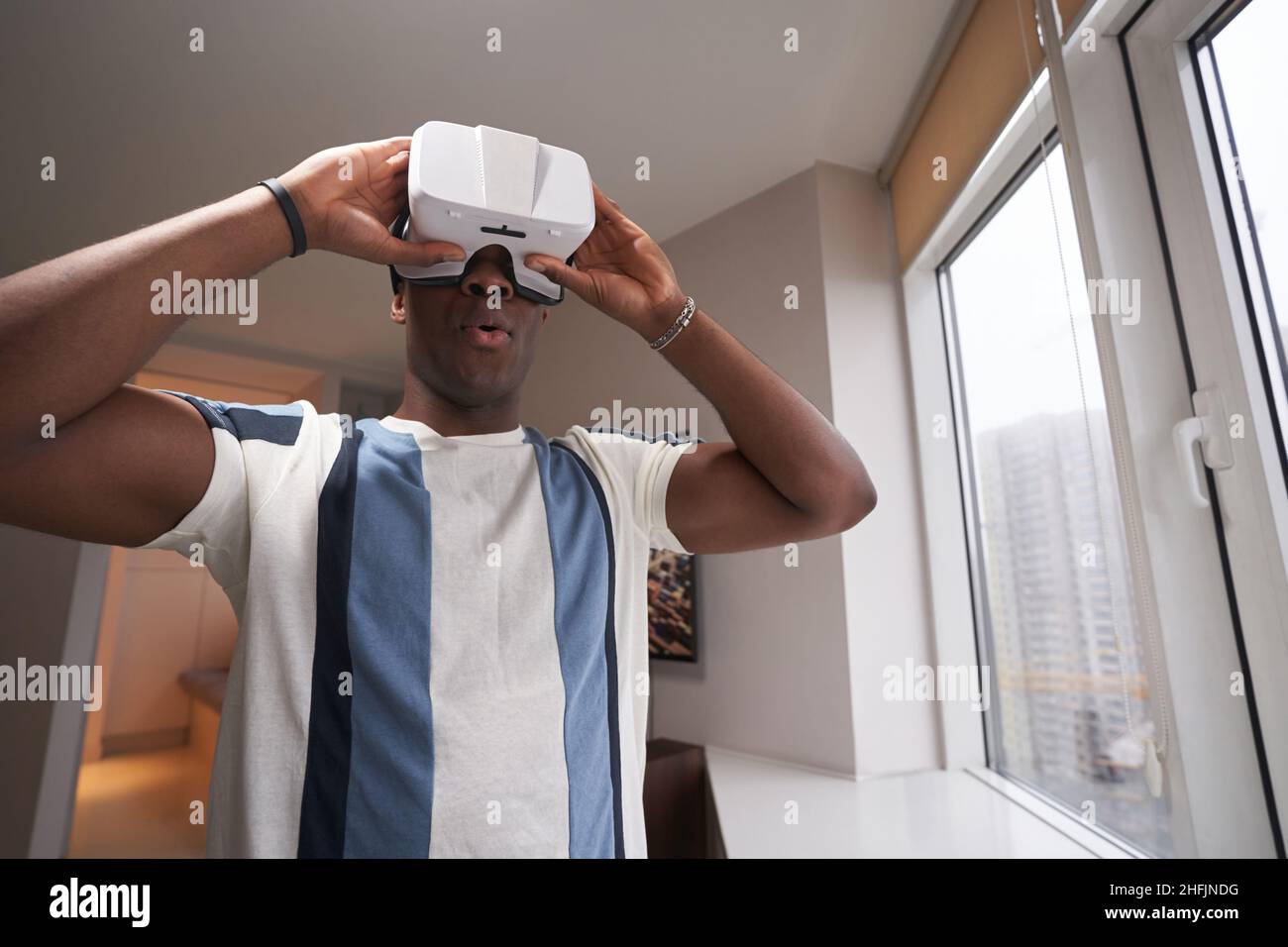 Male impressed by what he see through VR goggles Stock Photo - Alamy