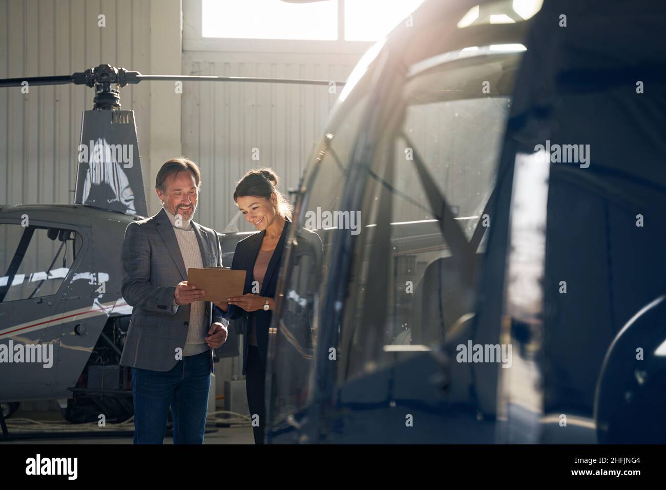 Female client signing documents before private helicopter flight Stock ...