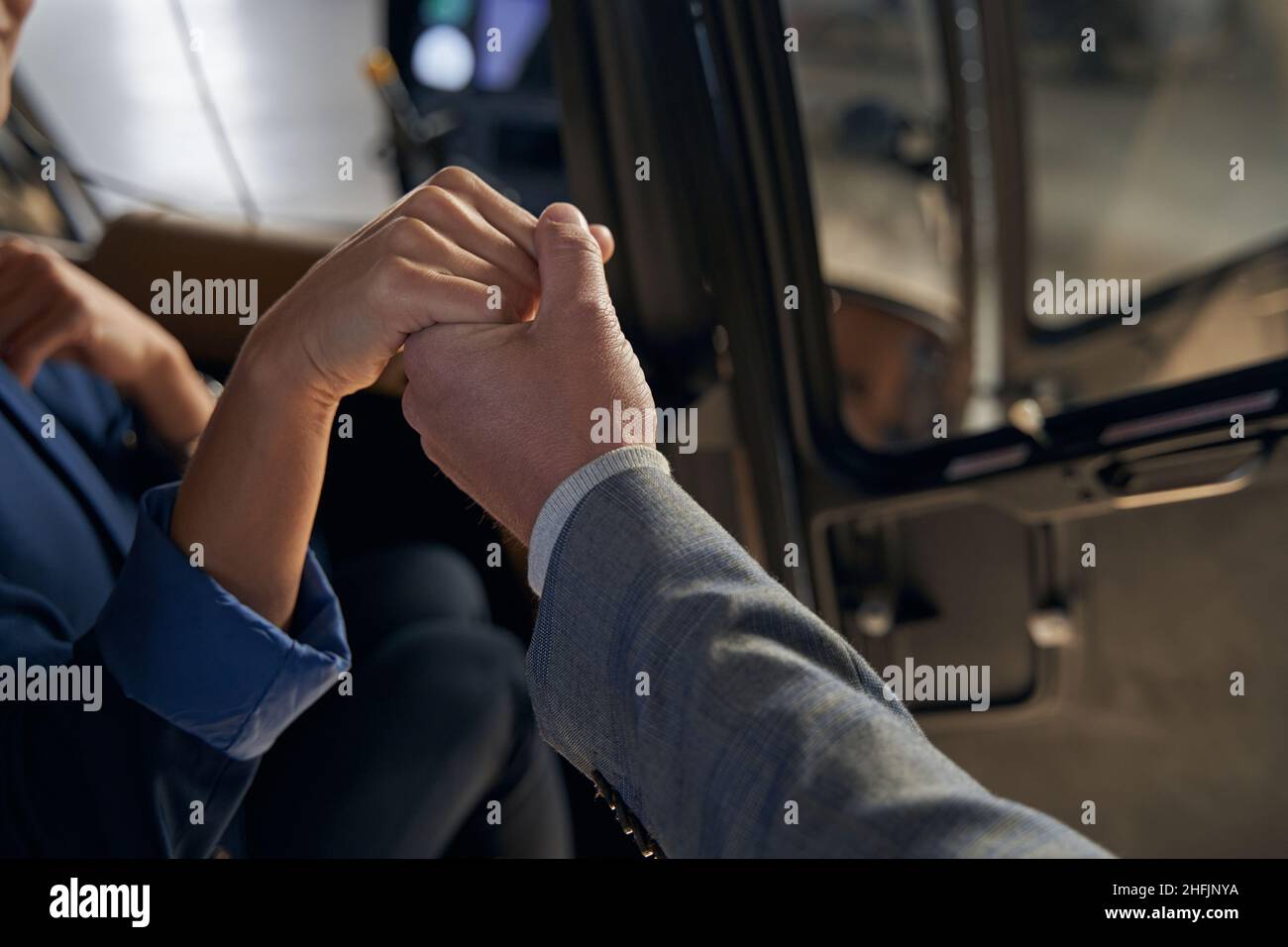 Pilot assisting passenger to alight from helicopter Stock Photo - Alamy