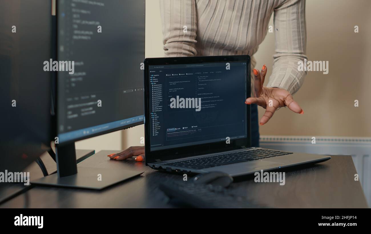 Closeup Of Laptop Running Algorithm Parsing Code On Desk In Front Of Programmers Doing Team Work