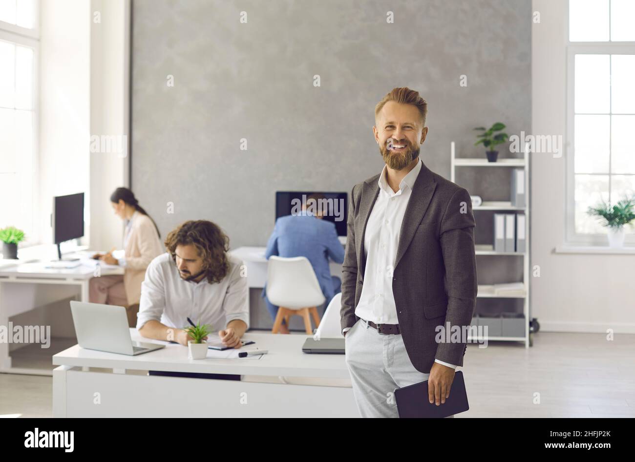 Portrait of smiling businessman pose in coworking office Stock Photo ...