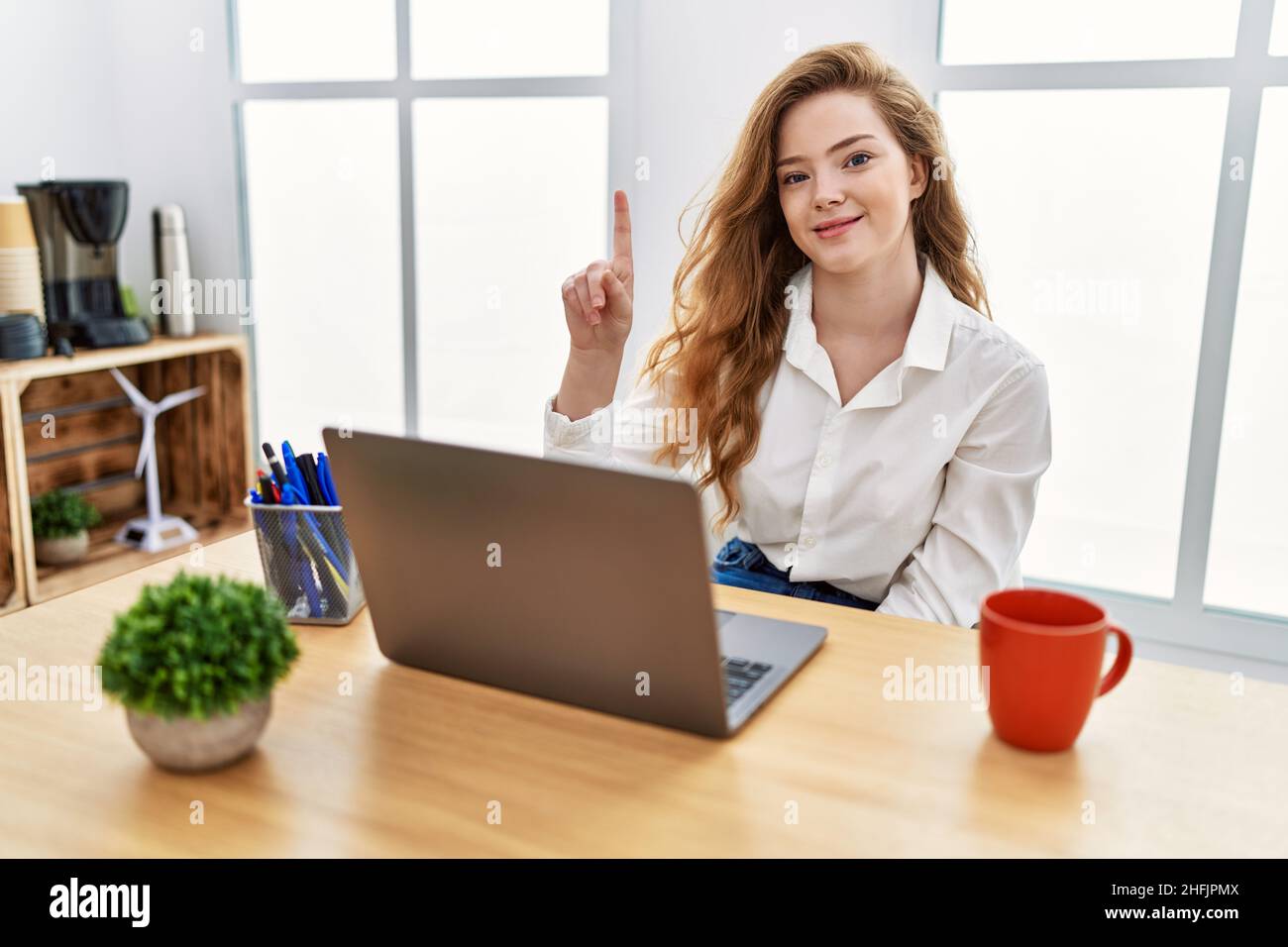 Young caucasian woman working at the office using computer laptop ...