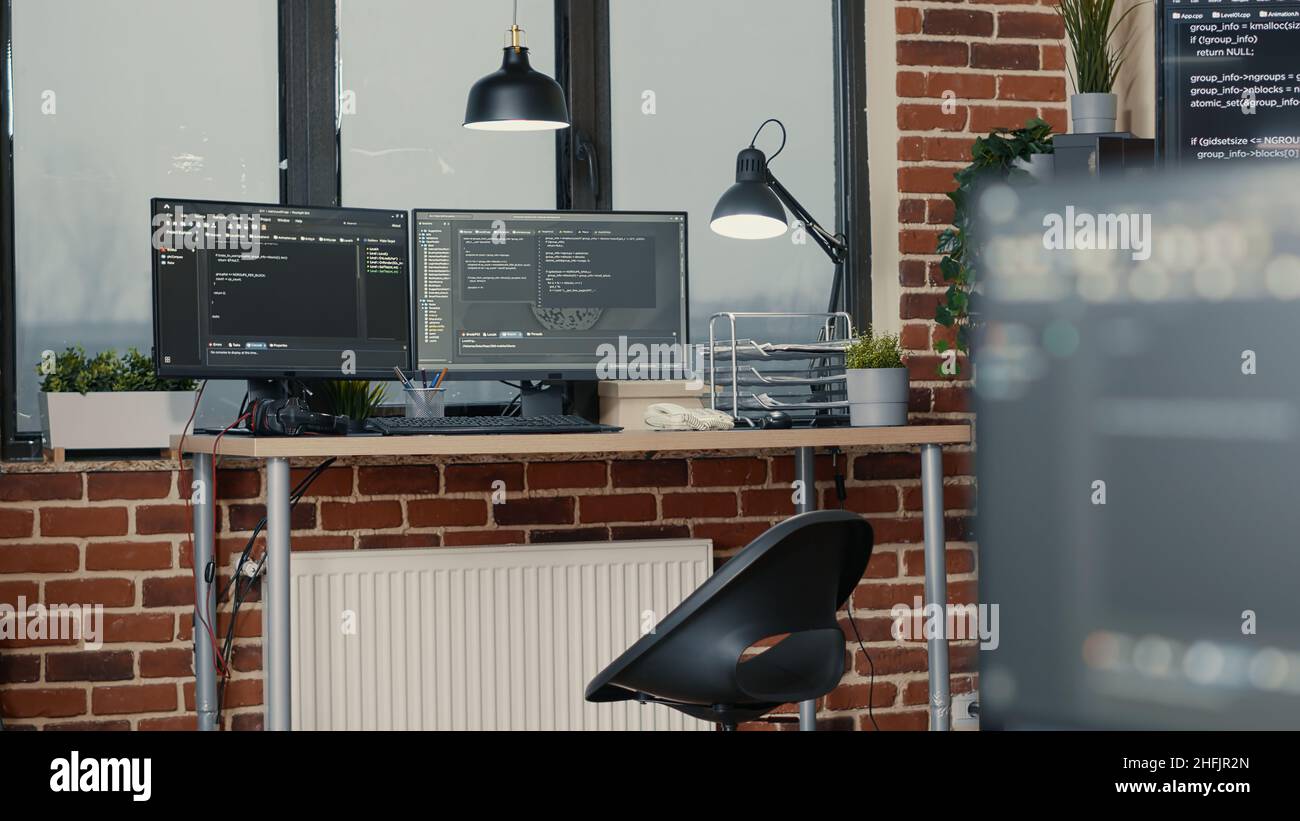 Desk With Multiple Computer Monitors Displaying Parsing Code And Programming Language Compiling