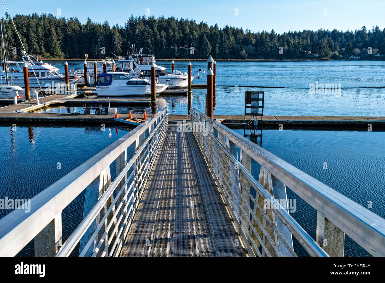 A metal walkway leads to the docks at the Port of Siuslaw Marina ...