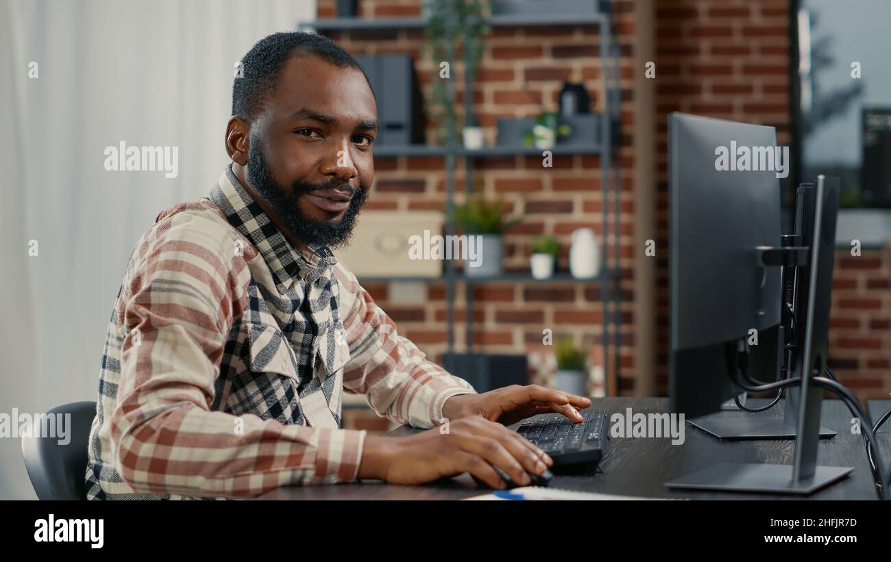 Portrait of programer typing programming code on computer keyboard ...