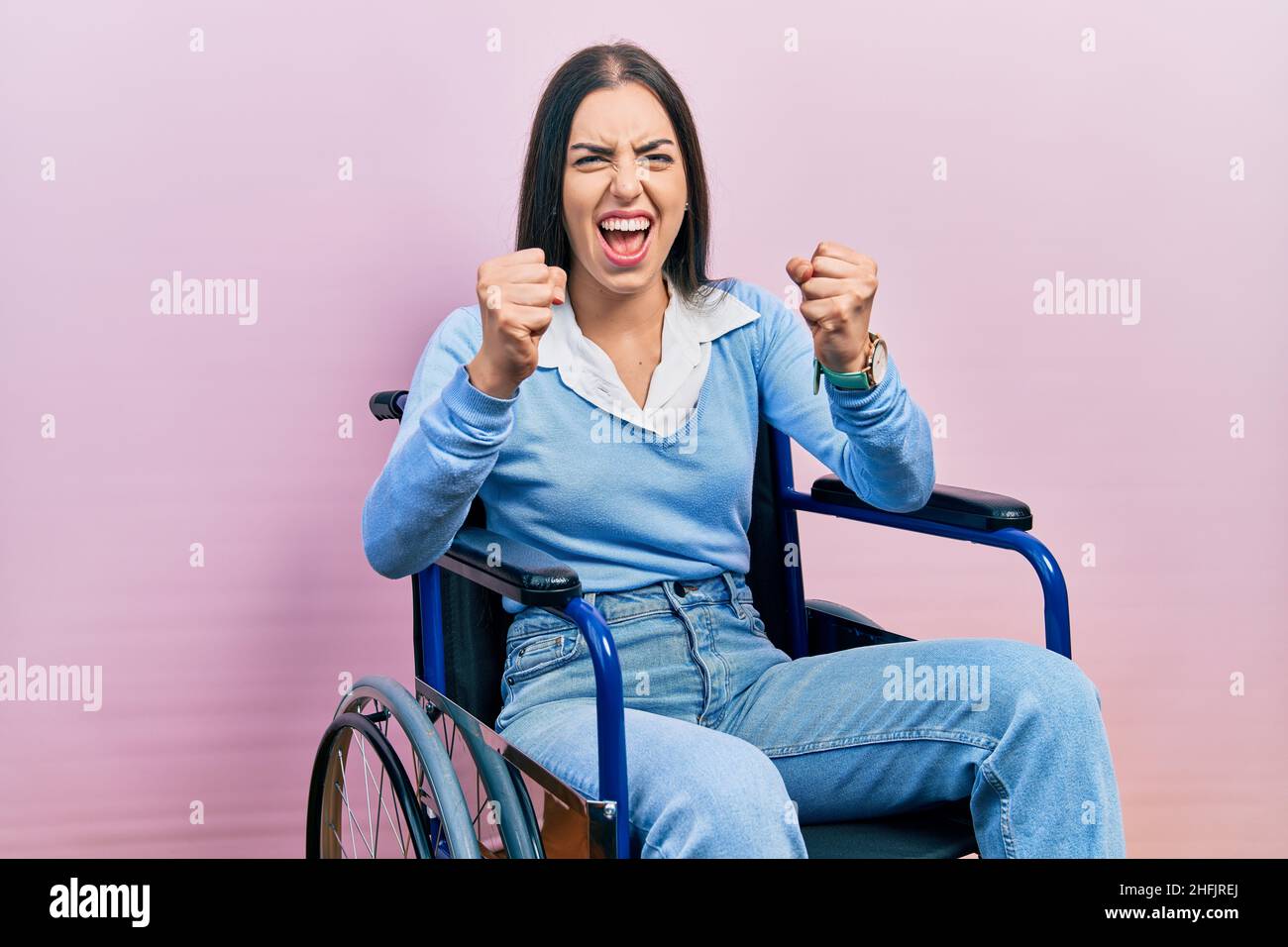 Beautiful woman with blue eyes sitting on wheelchair angry and mad ...