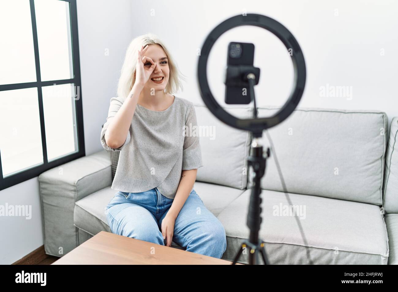 Young caucasian woman recording vlog tutorial with smartphone at home ...