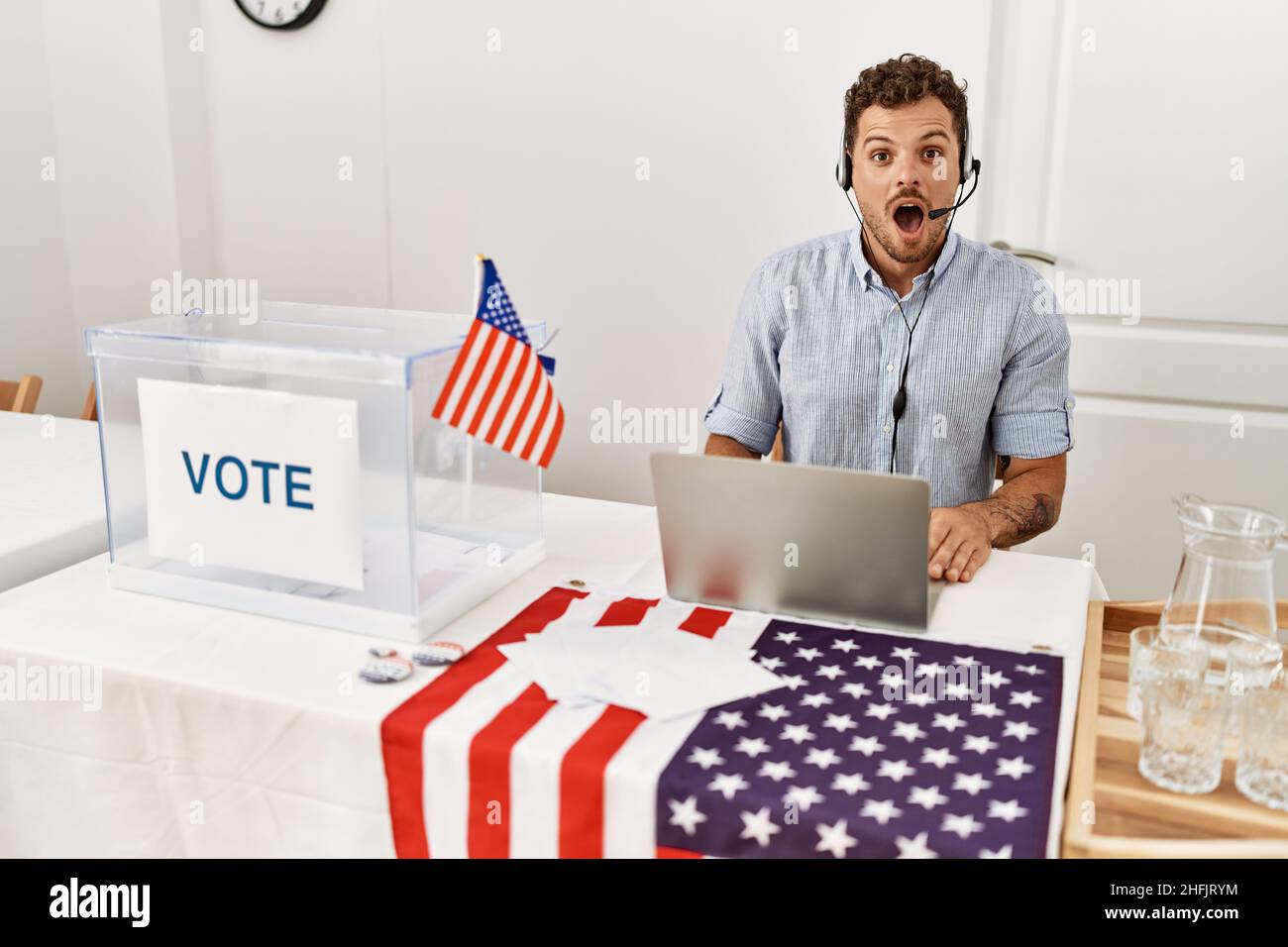 Handsome young man working at political campaign wearing operator head ...