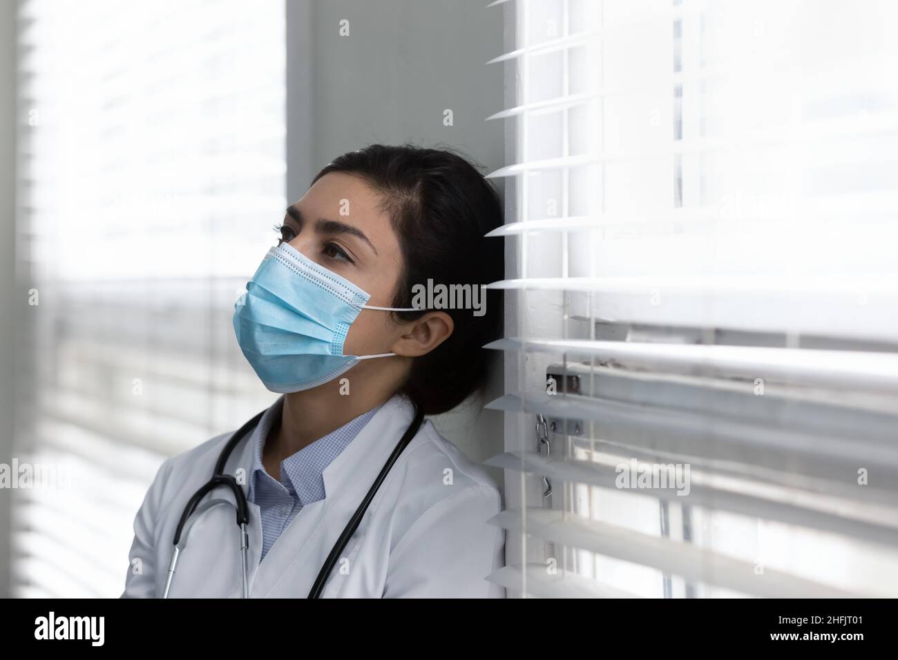 Unhappy young Indian doctor feeling exhausted in clinic Stock Photo - Alamy