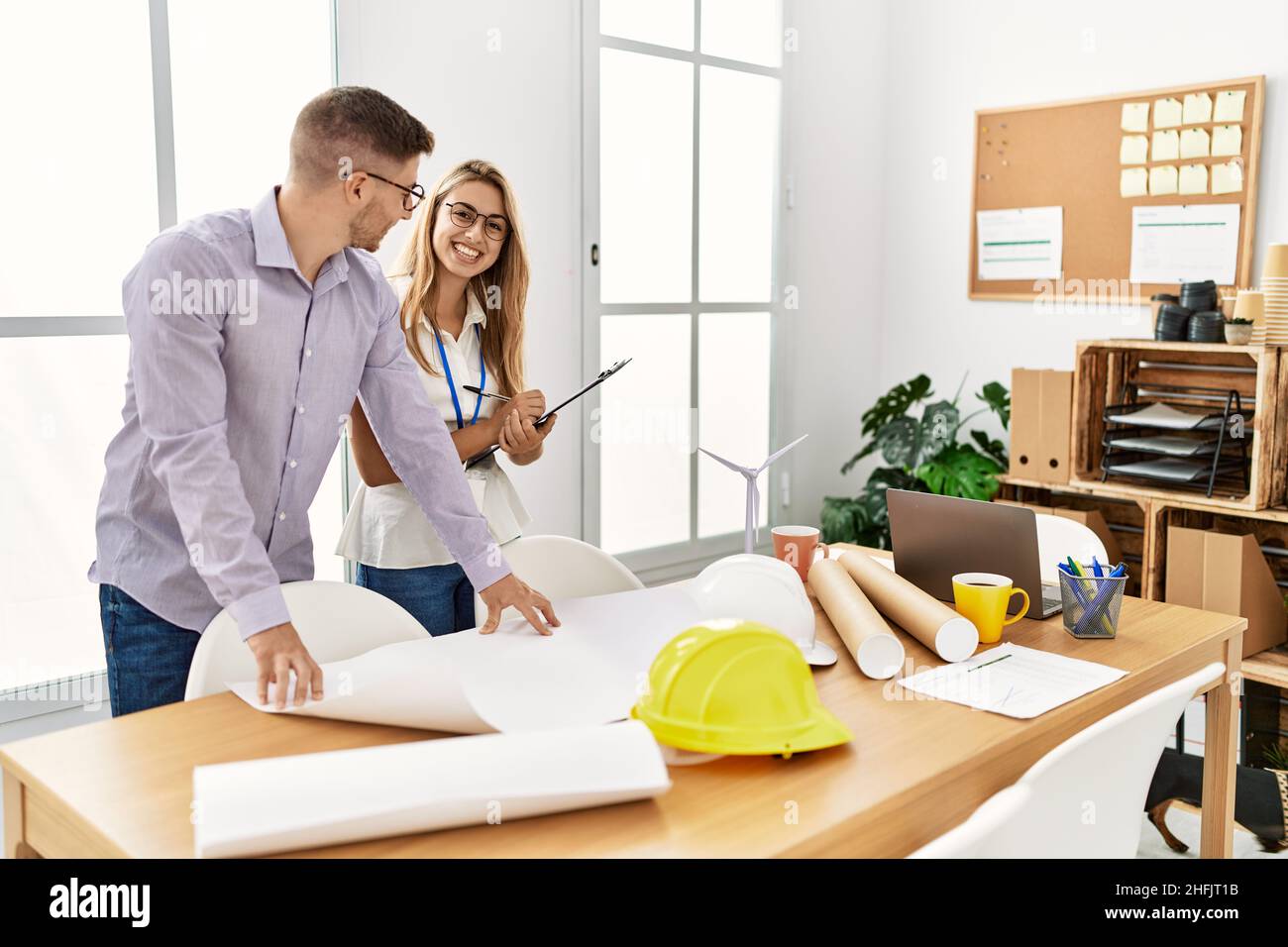 Two young architect smiling happy working at architecture studio Stock ...