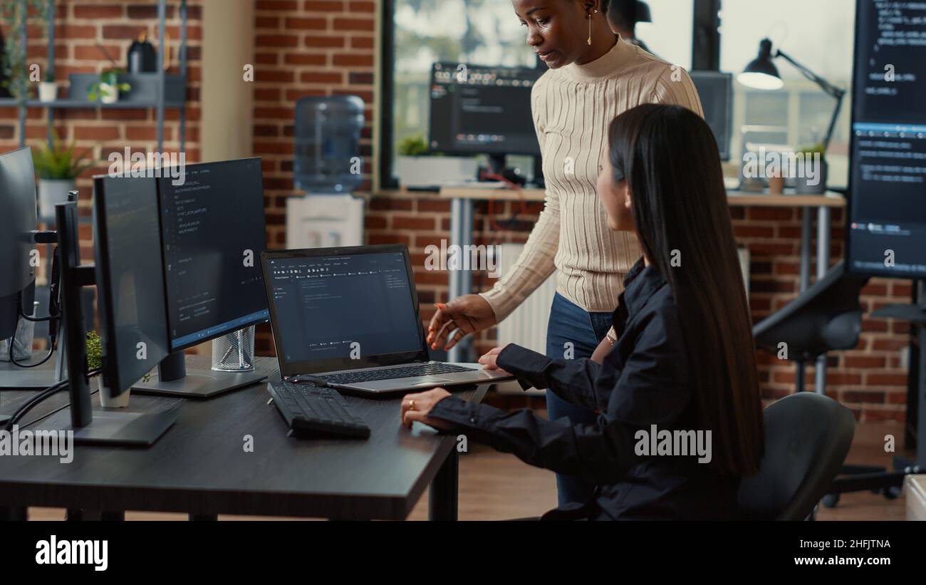 Coder Holding Laptop With Coding Interface Entering Software Development Agency Office Sitting