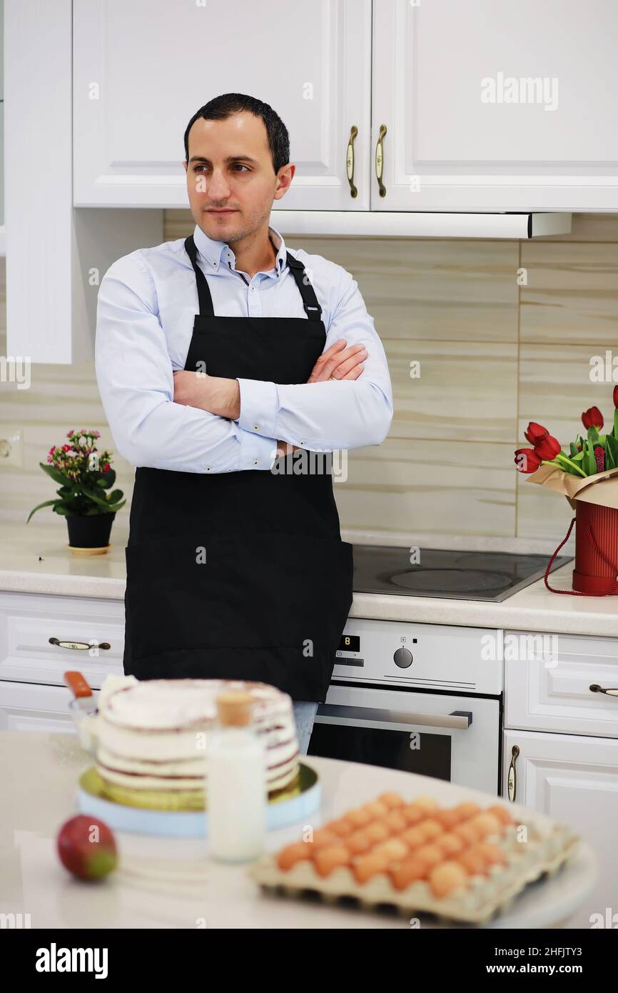 Master pastry chef in front of a desk. Cooking desserts at home. The ...