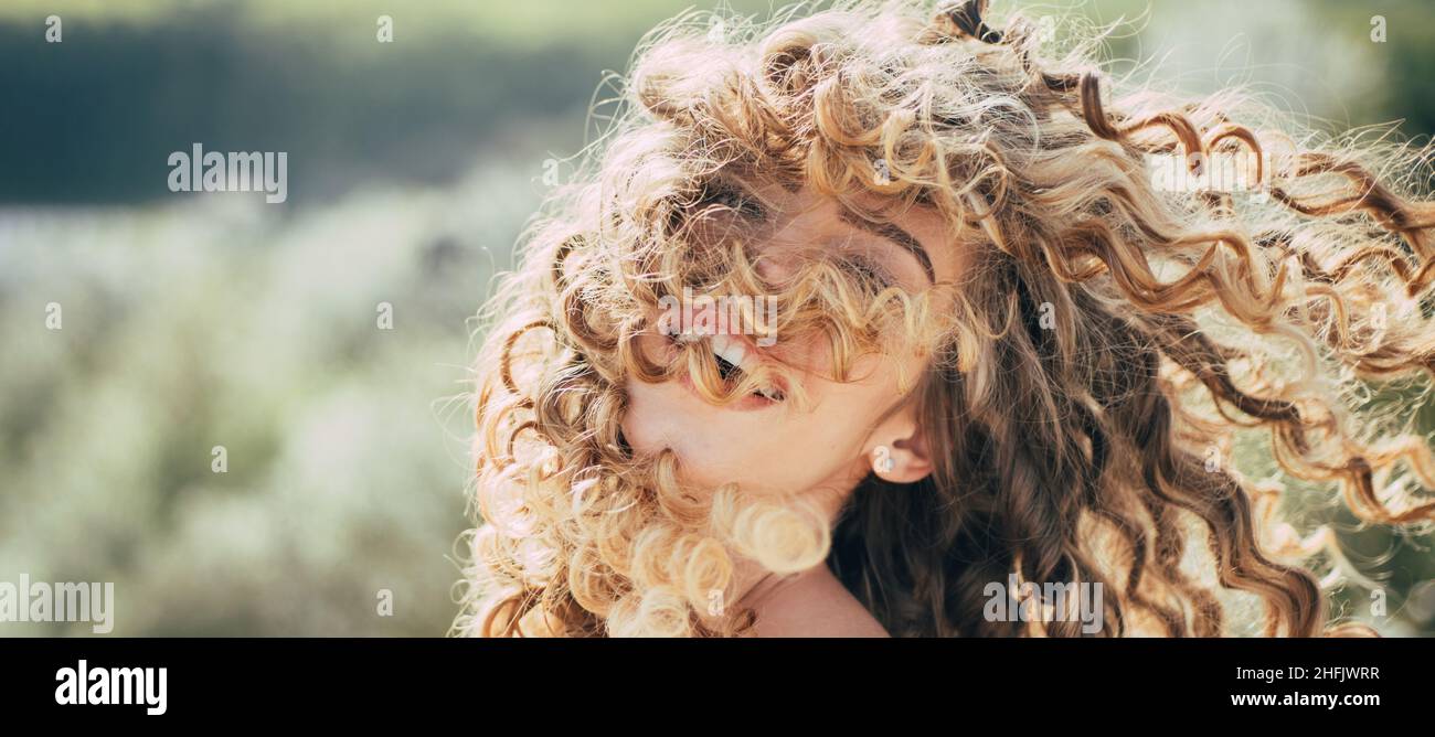 Blonde spring girl with curly beautiful hair smiling. Beauty hair Salon ...