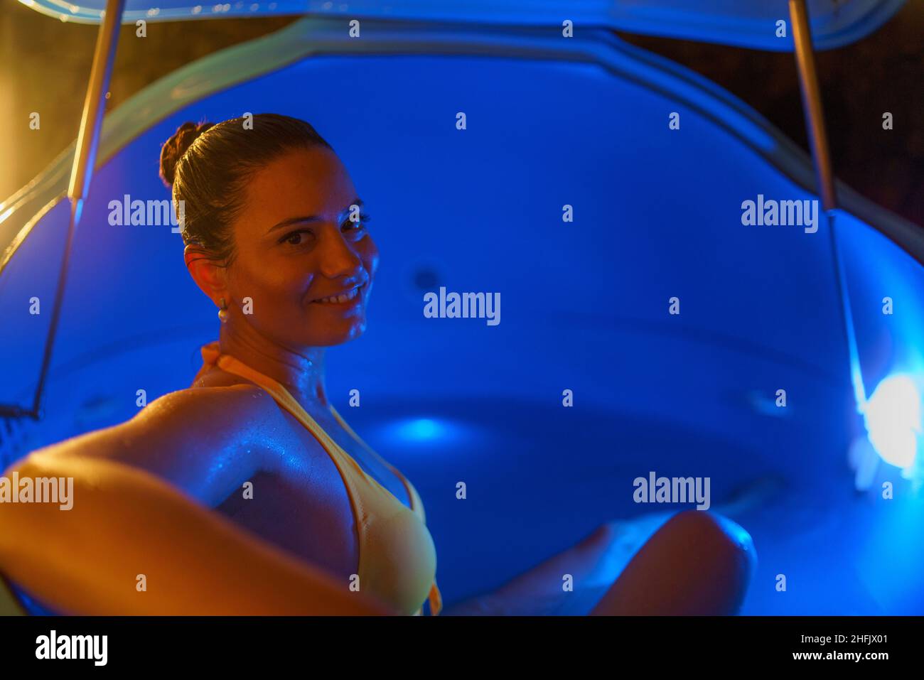 Beautiful woman floating in tank filled with dense salt water used in ...