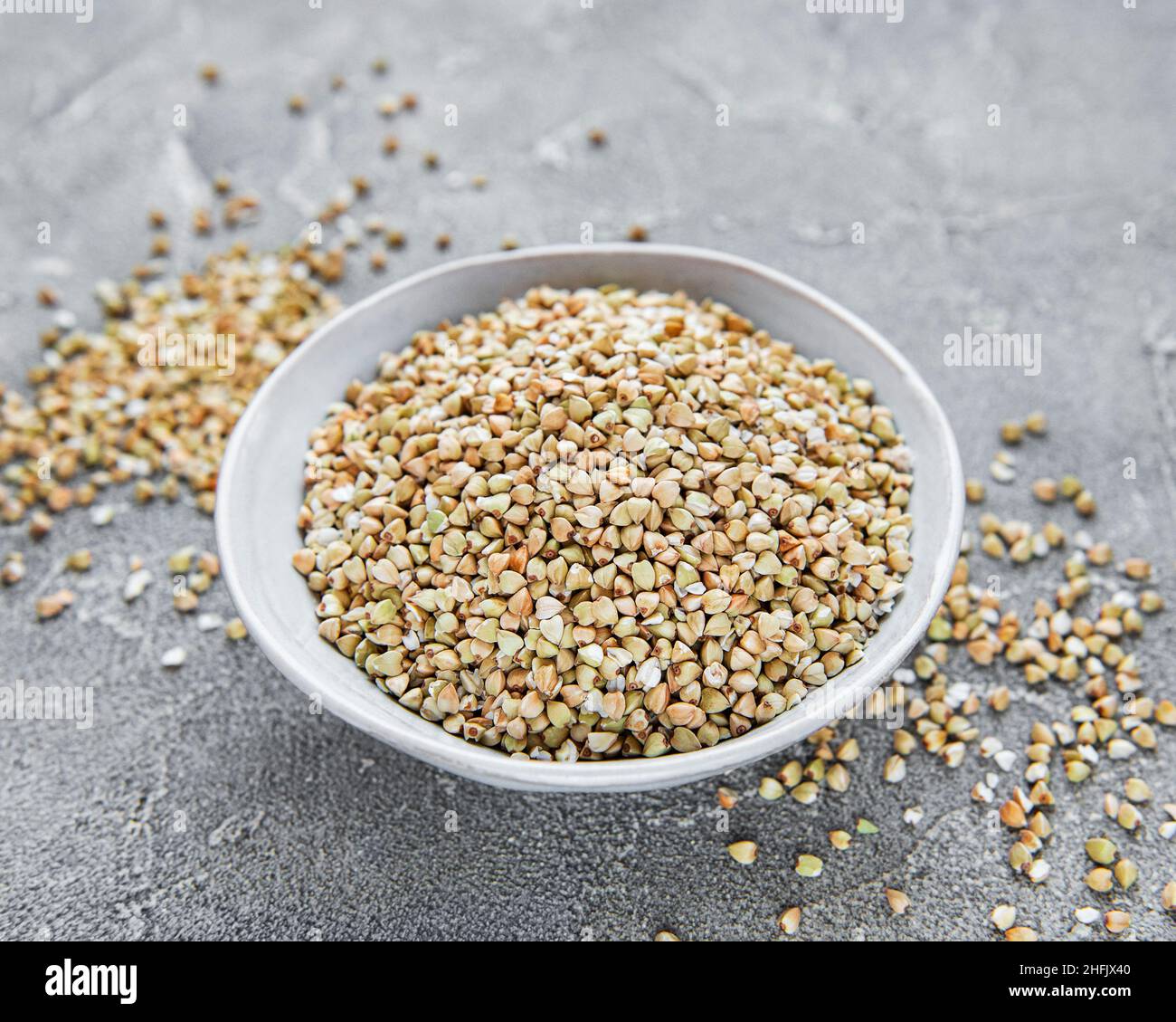 Organic green buckwheat on a grey concrete background Stock Photo - Alamy