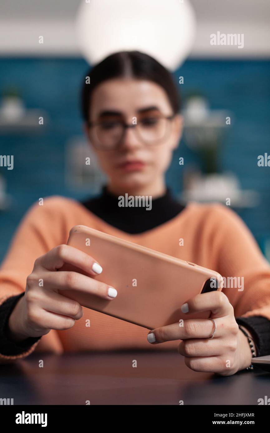 Student holding smartphone and looking at the screen. Programmer with ...