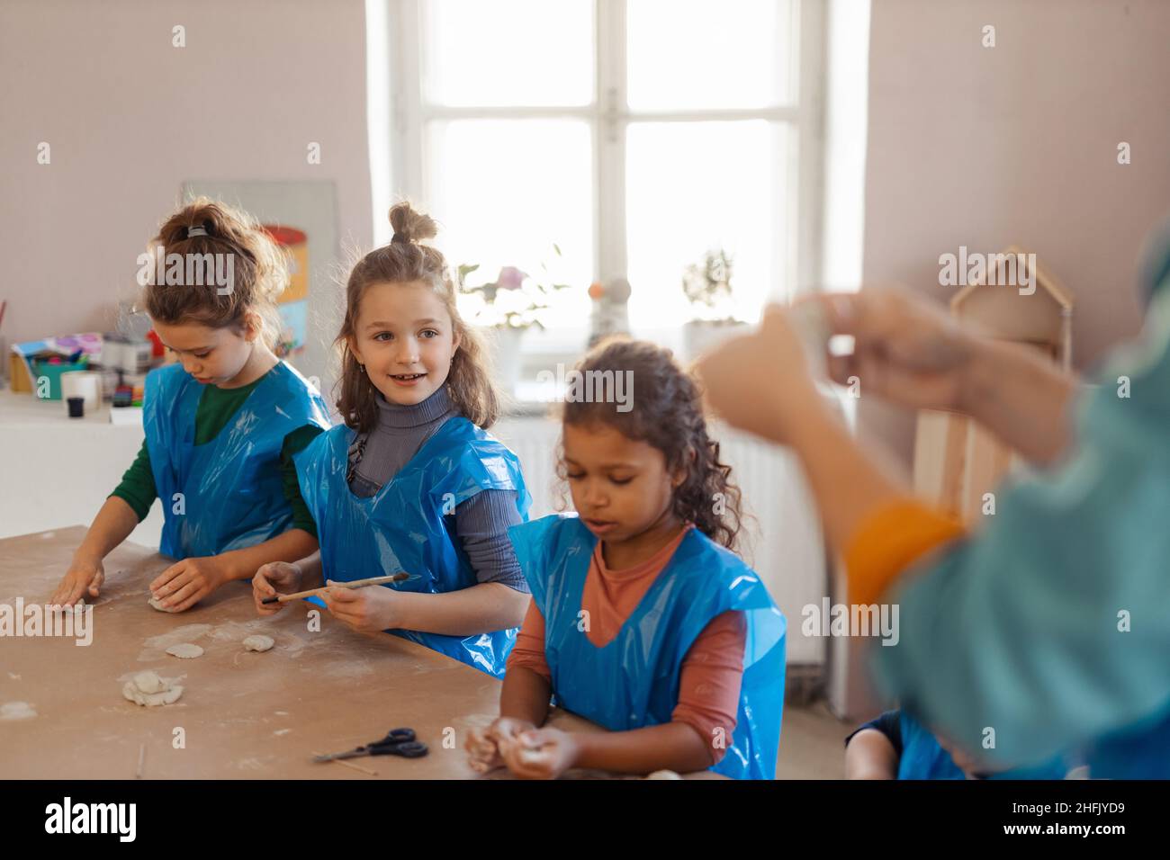 Group of little kids working with pottery clay during creative art and ...