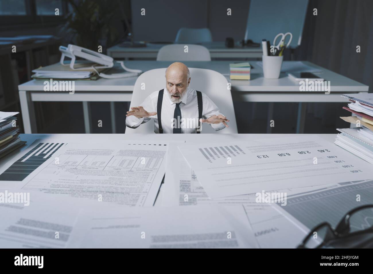 Desperate shocked businessman checking his company financial stats and ...