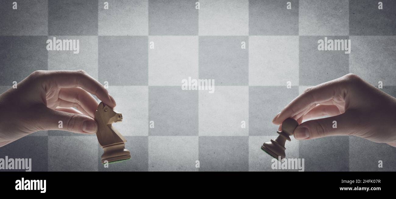 Chess players holding pieces and attacking each other, chessboard in ...
